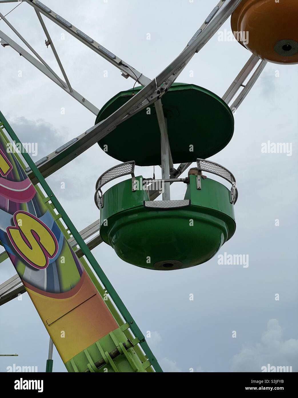 Child looking out of a Ferris wheel bucket in the air Stock Photo - Alamy