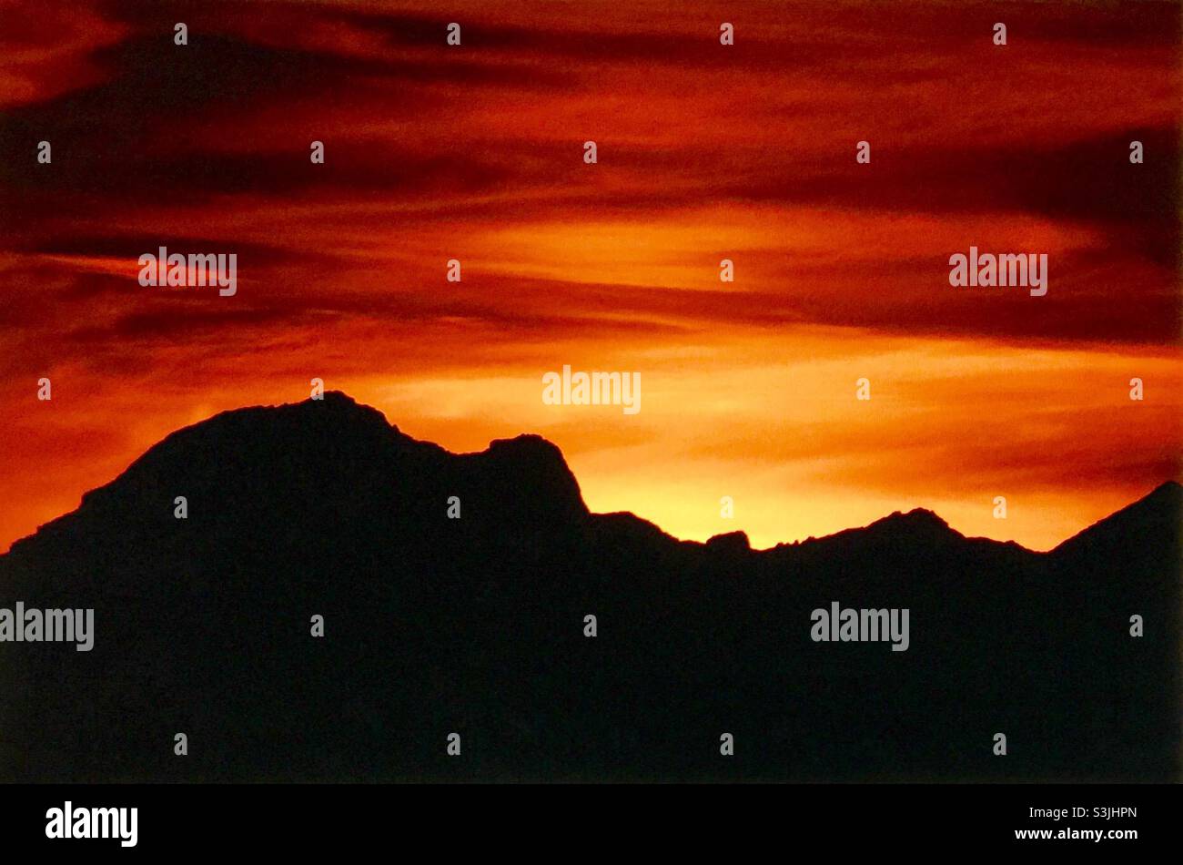 Sunset over the Rockies along highway 1A over looking the town of ...