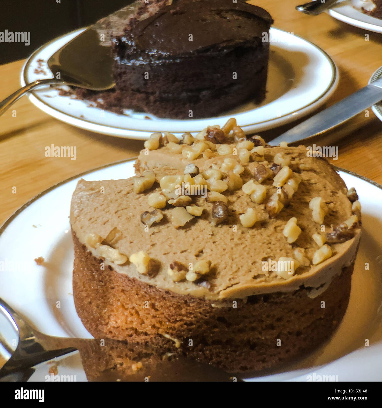 Chocolate cake and walnut cakes with missing slices Stock Photo - Alamy