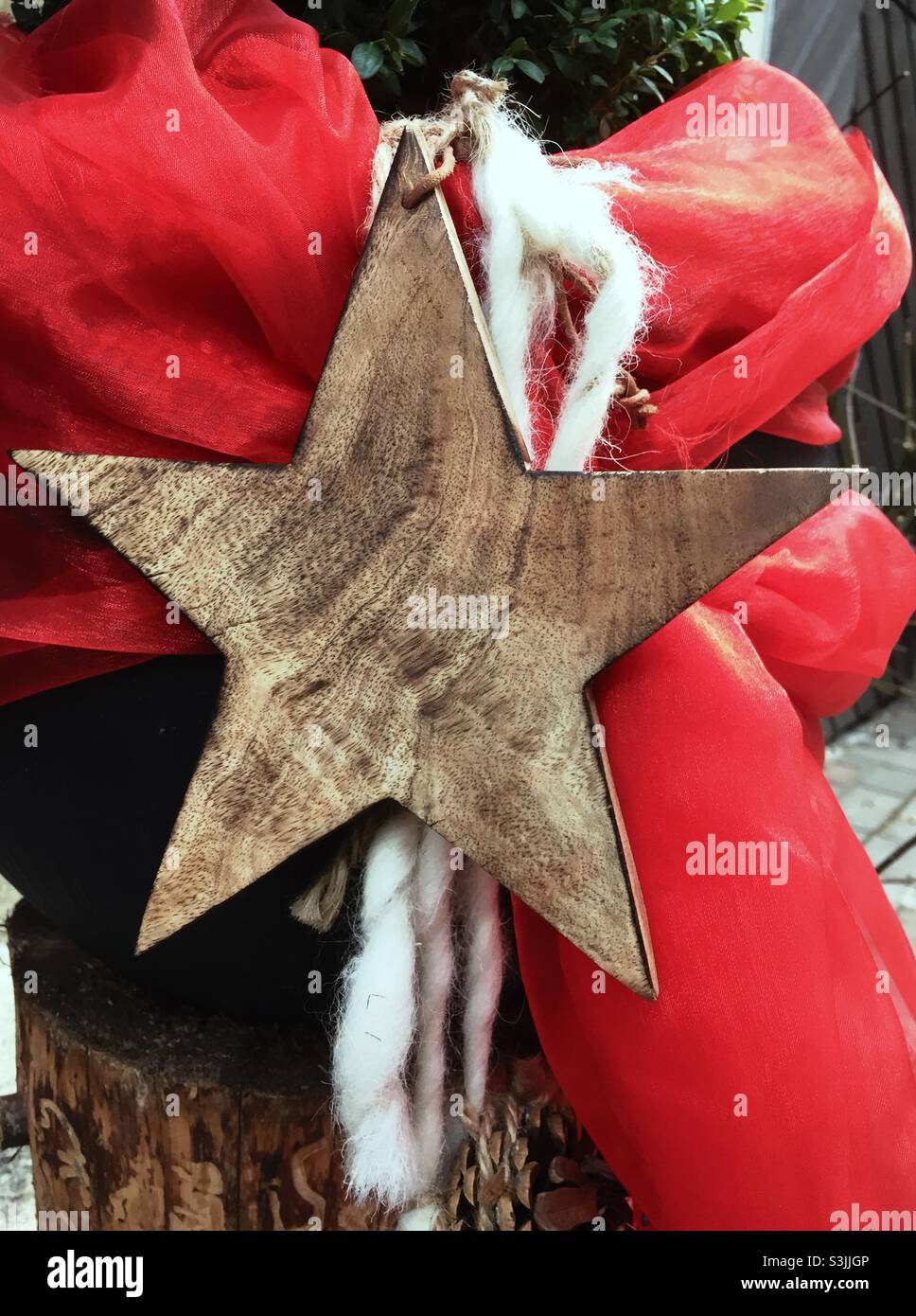 Christmas decoration with wooden star and red ribbon Stock Photo - Alamy