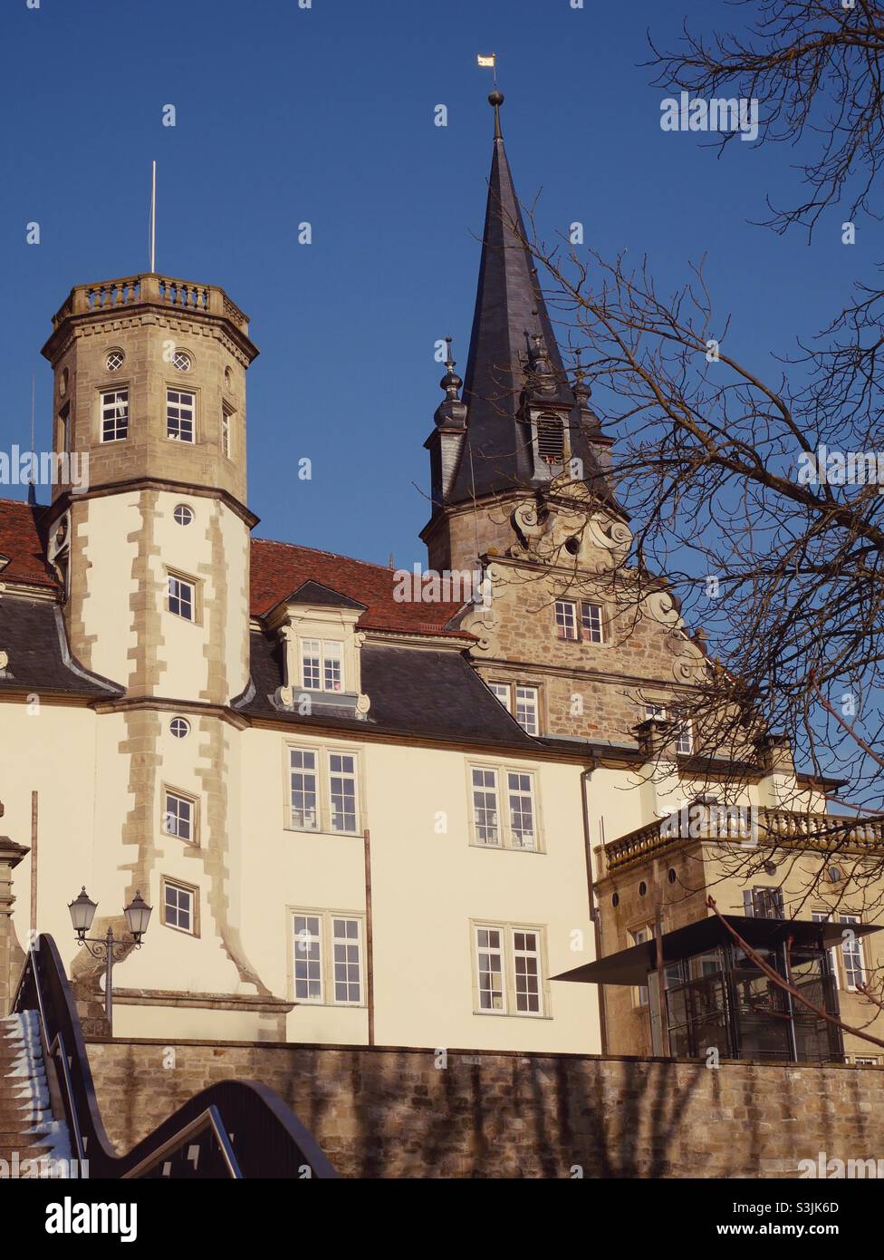 Medieval townhouse and clock tower of church in Oehringen in Germany ...