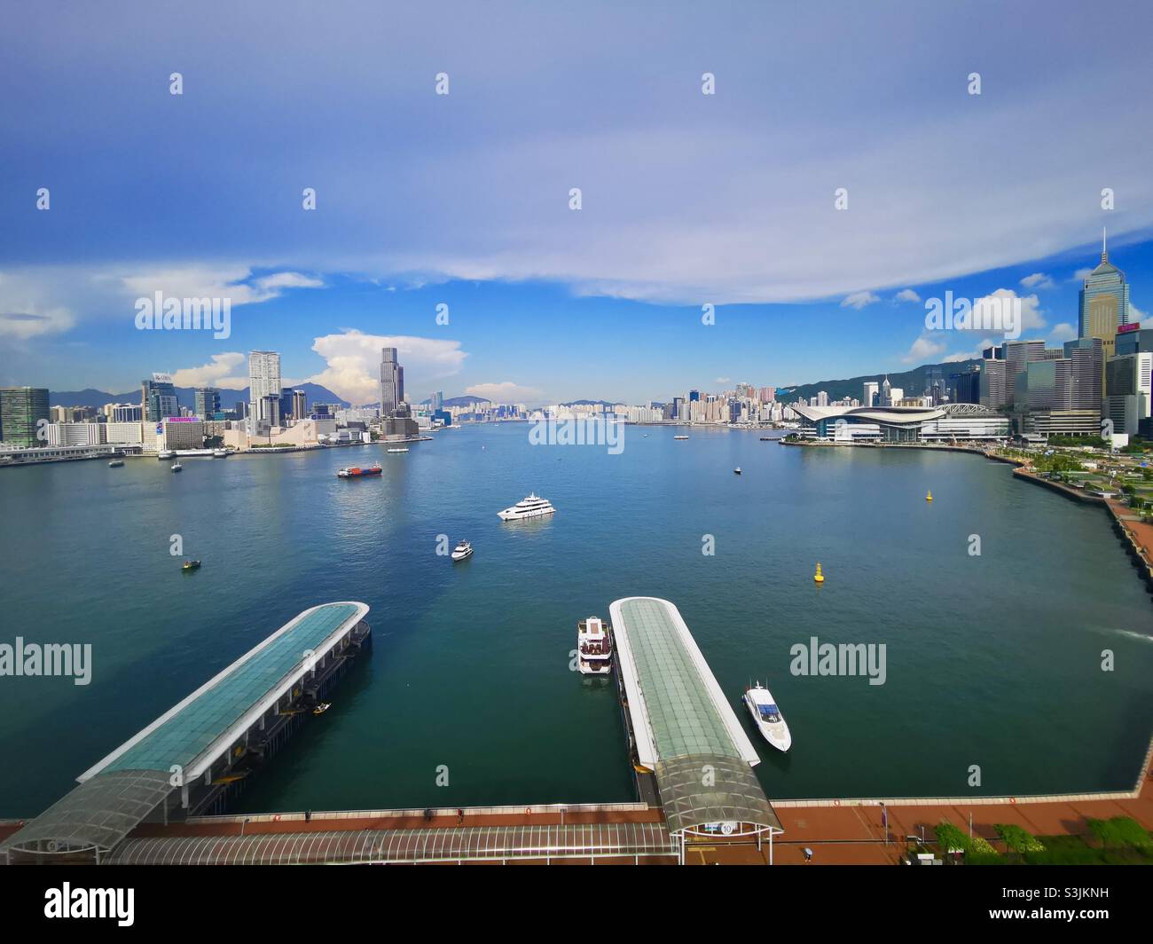 A view of Victoria harbour and the The HK island waterfront promenade ...