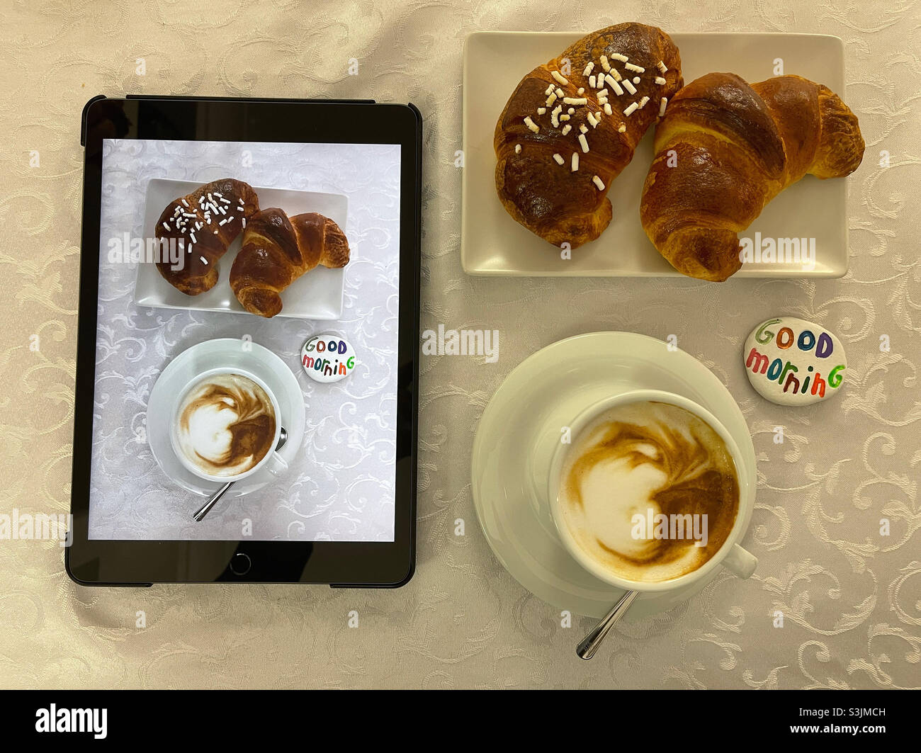 Social breakfast with cappuccino and croissants Stock Photo - Alamy