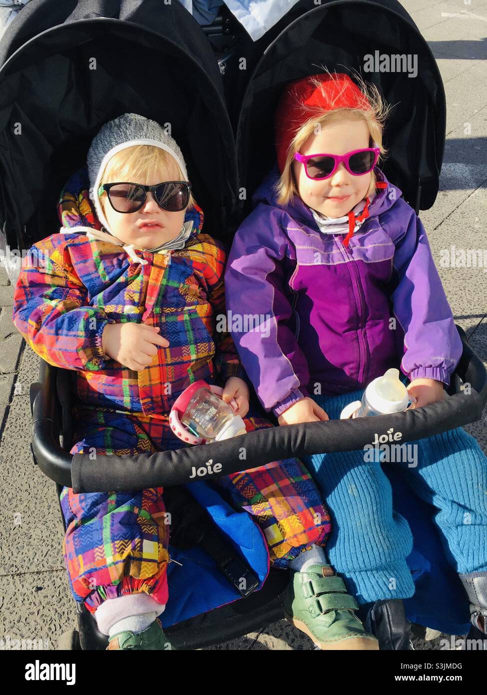 Two children in colorful snowsuits hi-res stock photography and images ...