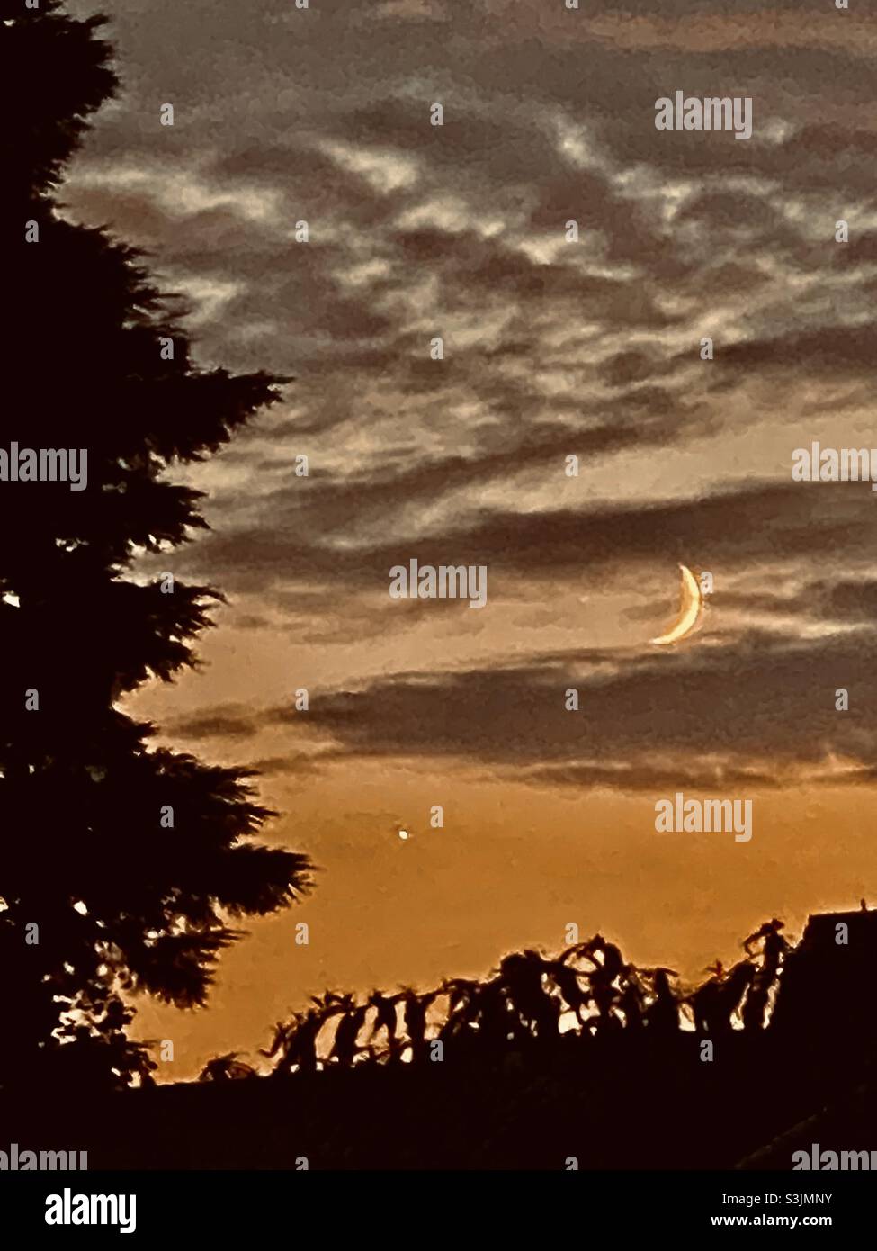 Crescent moon and clouds at sunset hi-res stock photography and images ...