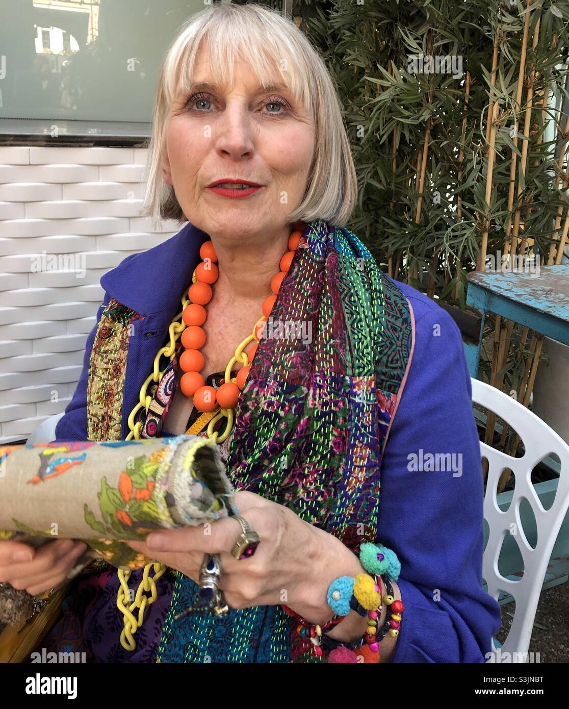 Woman colorfully dressed at London’s Spitalfields market weekly ...