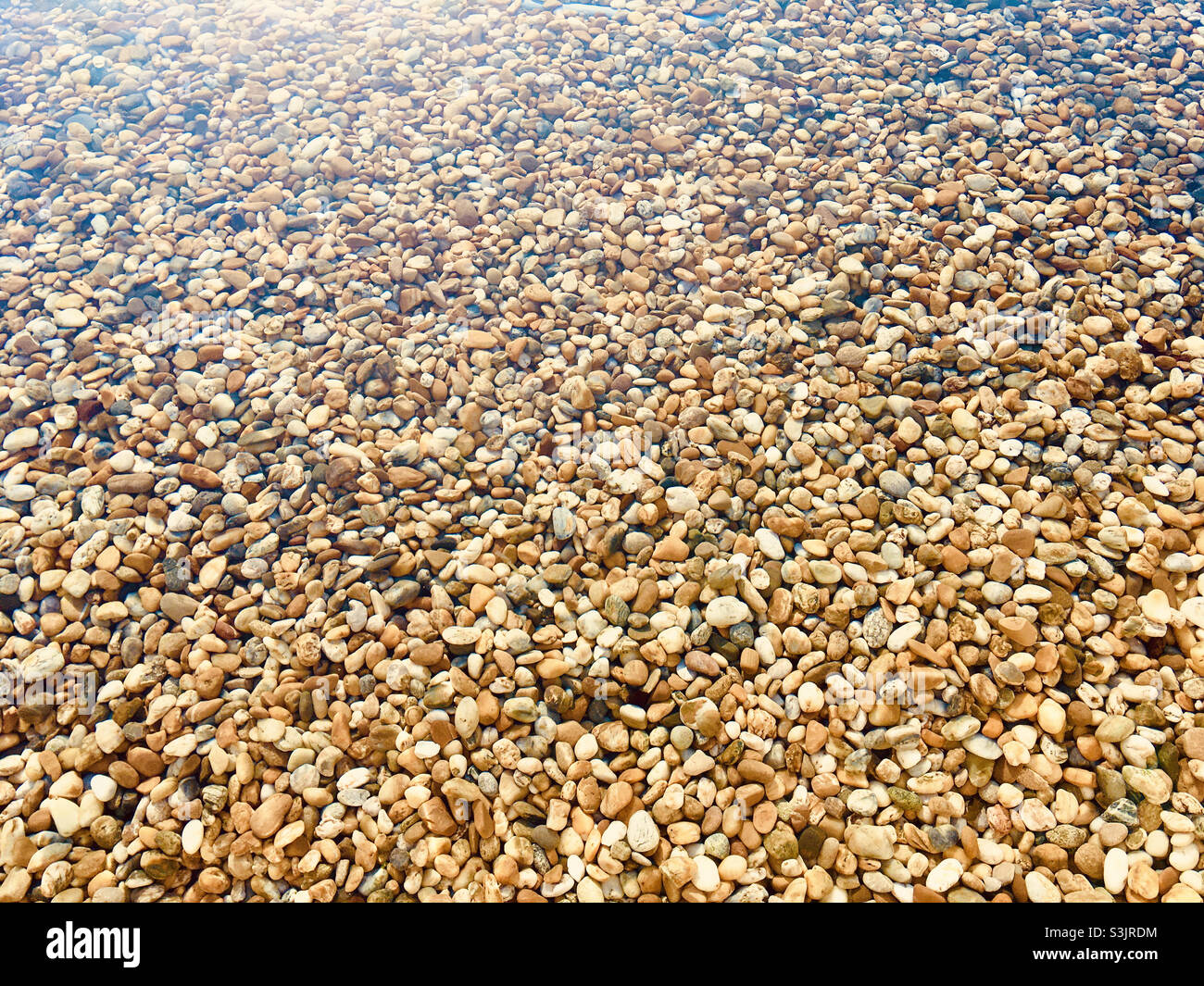 Bottom of pool covered with pebbles Stock Photo - Alamy