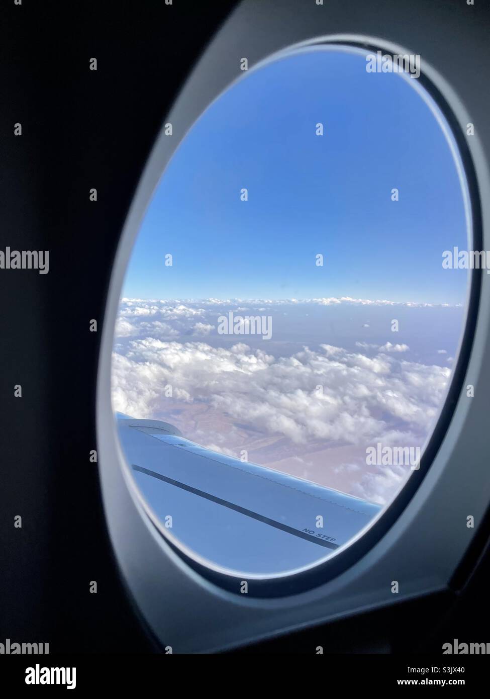 View through an aeroplane window, sky clouds and aircraft wing Stock ...