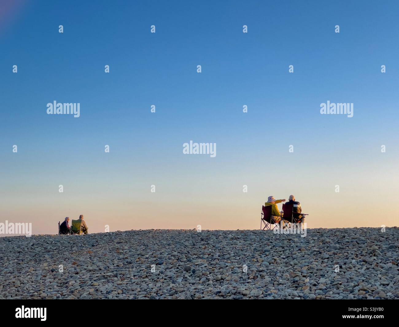 People watching the sunsetting Stock Photo - Alamy