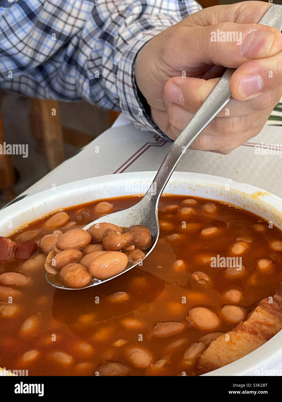 Eating beans stew Stock Photo - Alamy