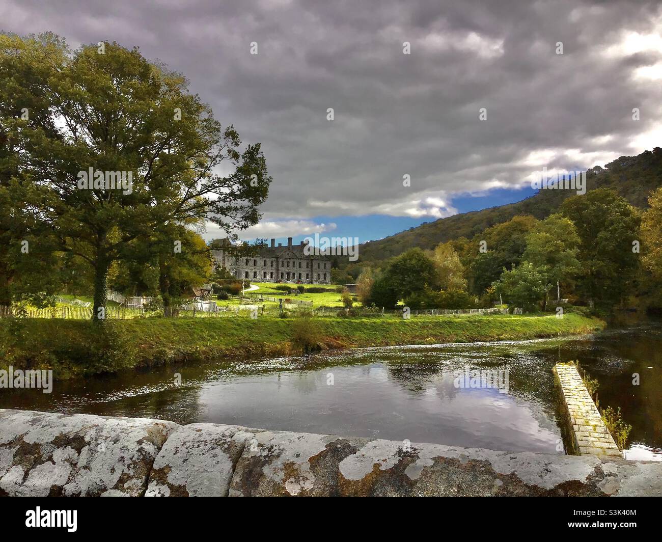 Bon Repos Abbey from weir bridge in Brittany Stock Photo - Alamy
