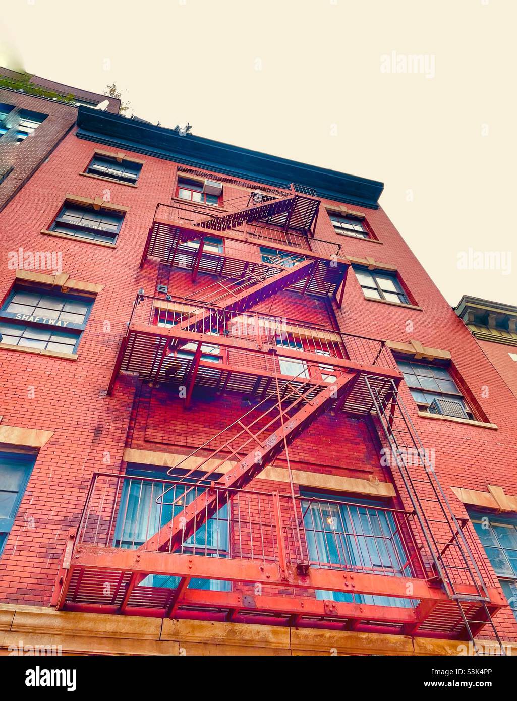 Metal fire escape on prewar red brick building in Chelsea, New York ...