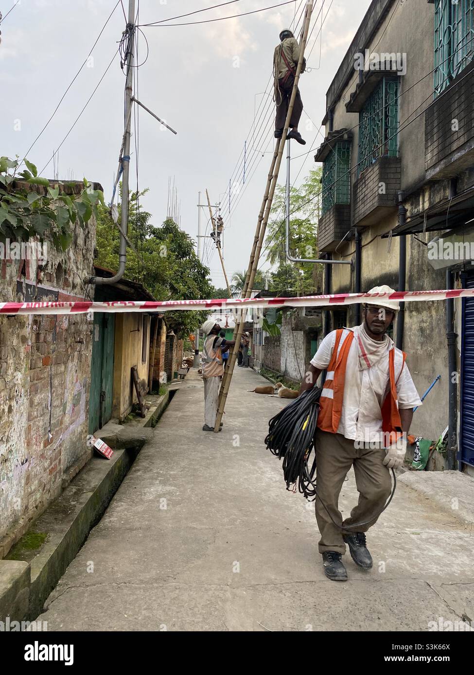 Electricity maintenance people working on power lines in city area ...