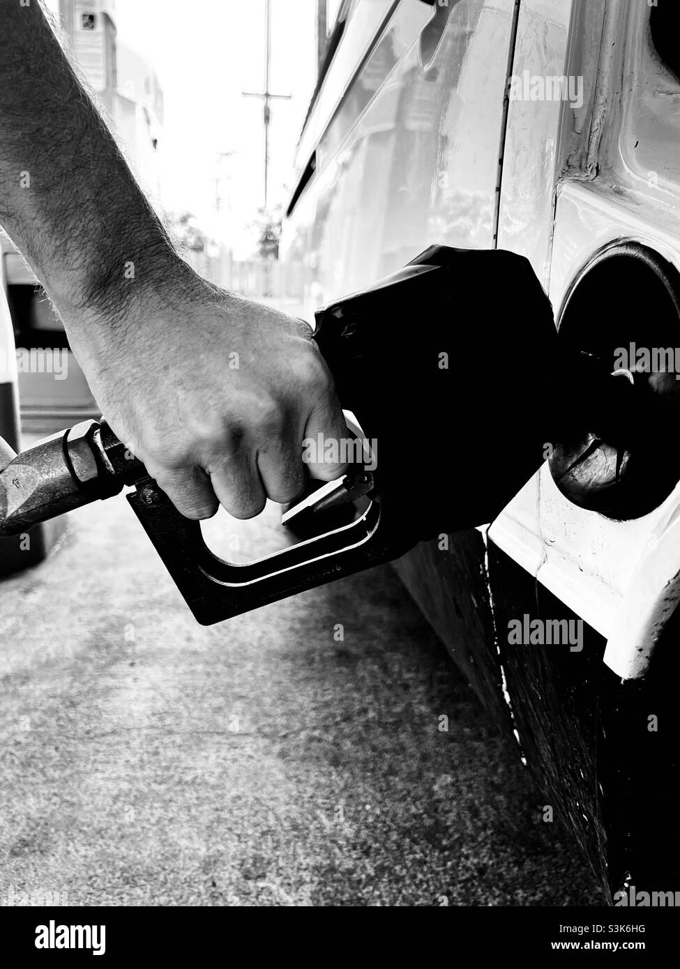 Man filling up car with gas Black and White Stock Photos & Images - Alamy
