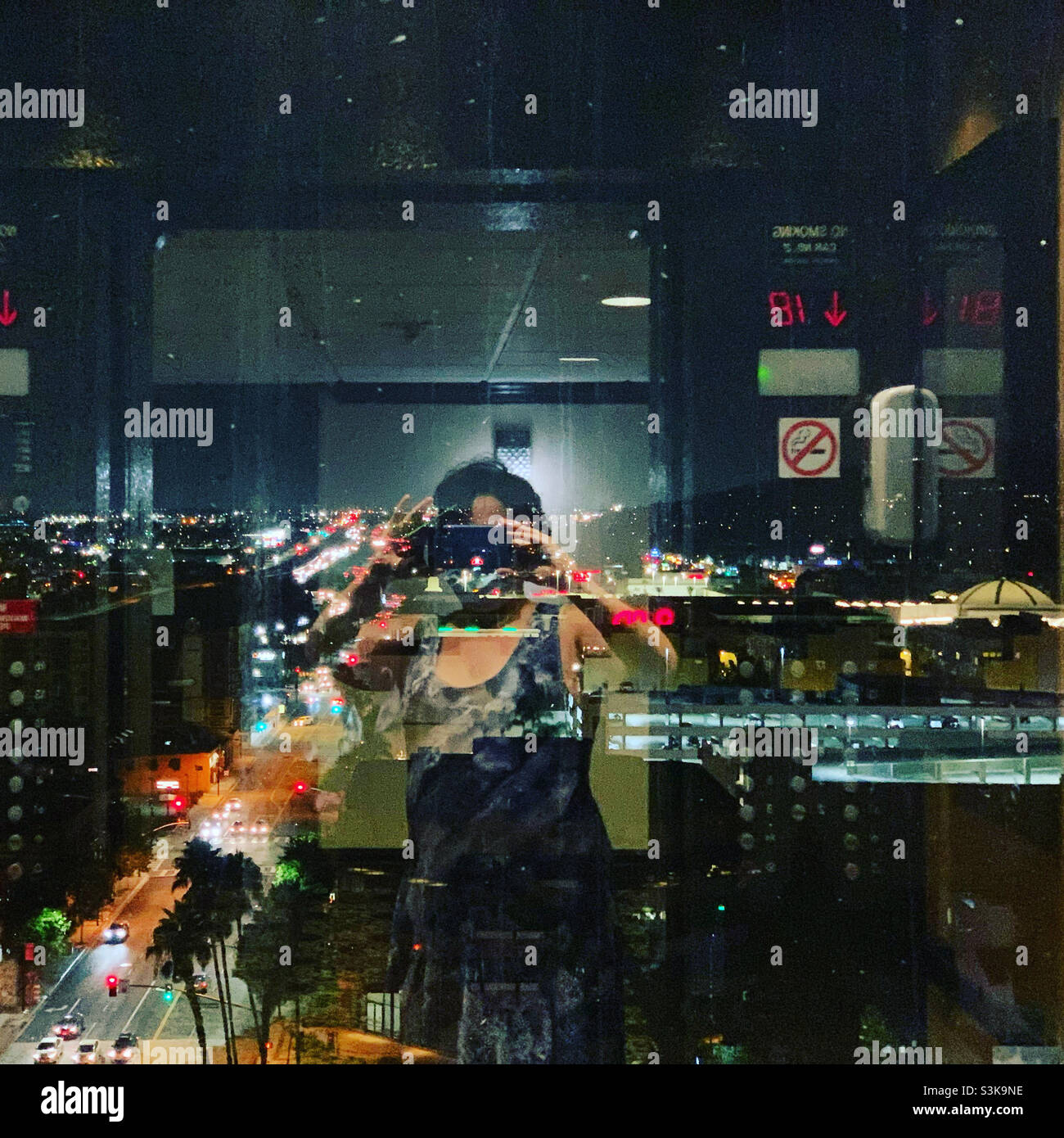 Taking a picture at night in a glass elevator at the Holiday Inn ...