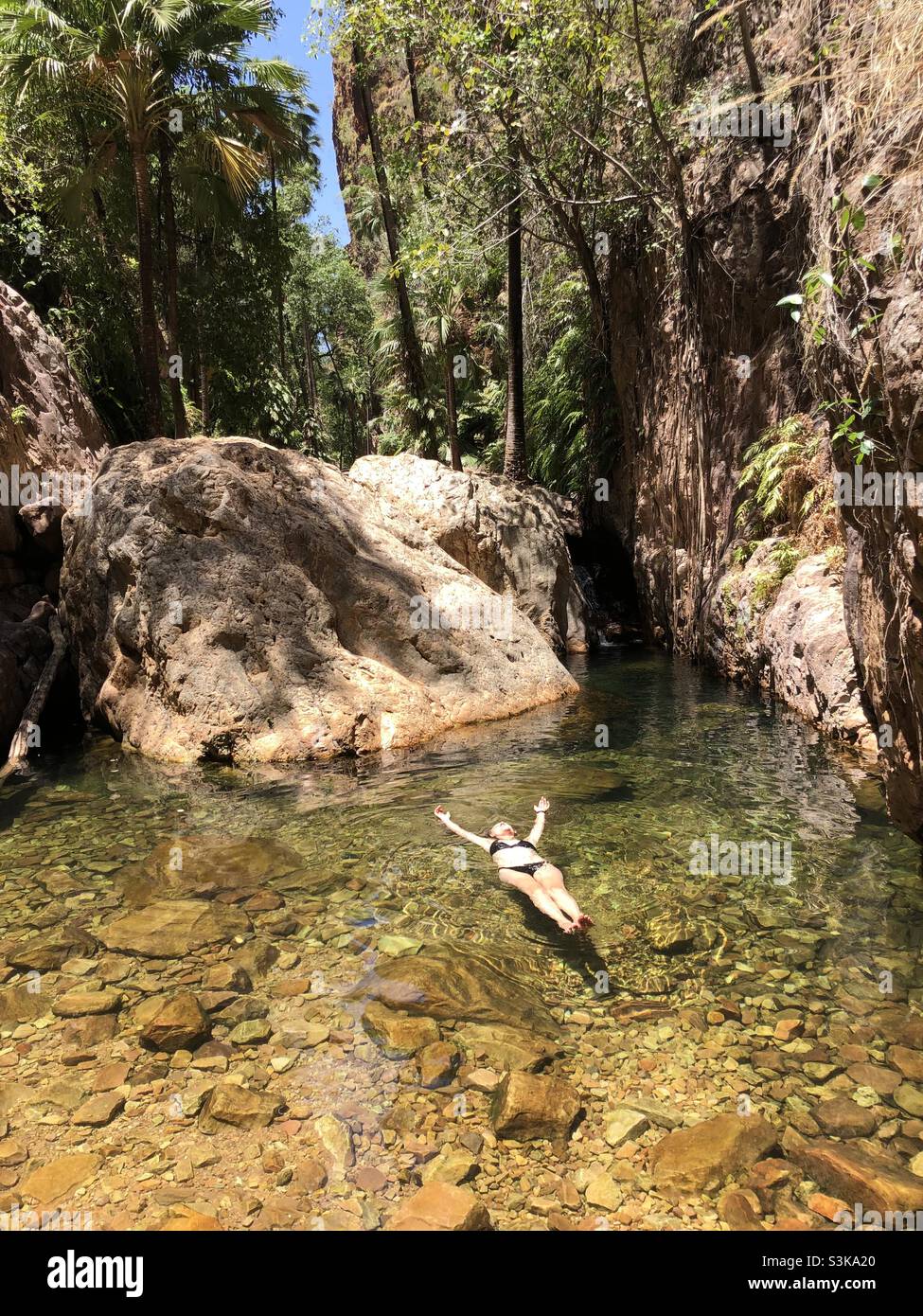 A woman floats in a clear rock pool in the outback in Australia Stock ...