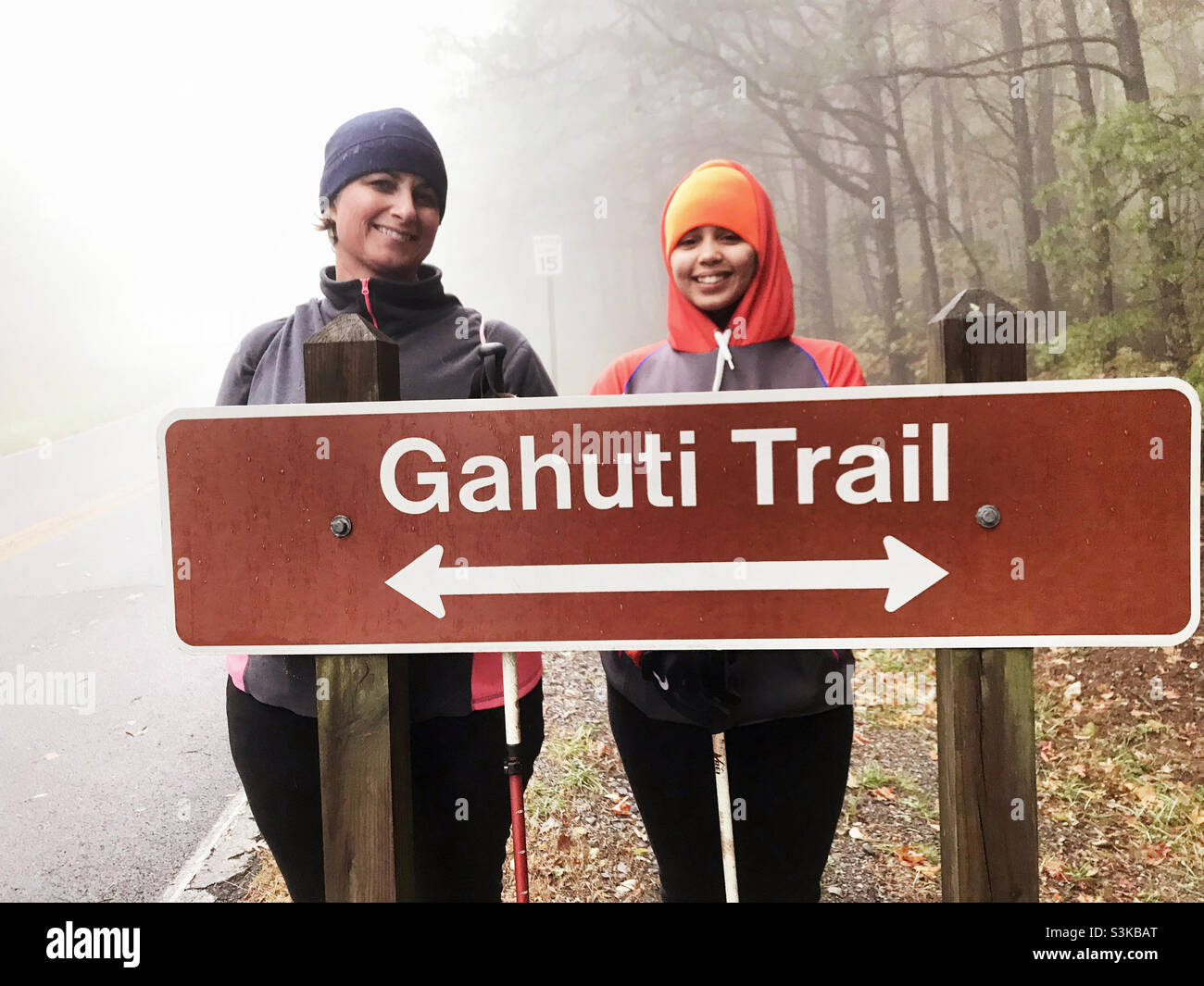 Female mountain hikers posing at the Gahuti Trail sign at Fort Mountain ...