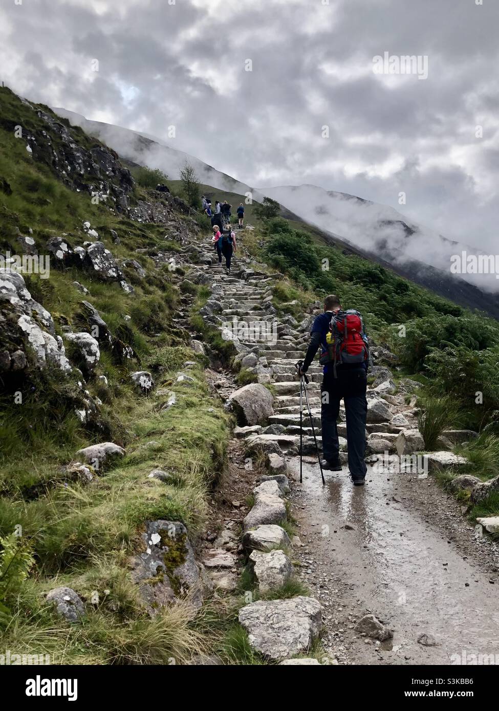 People starting to walk up the steep path of Ben Nevis in Scotland ...
