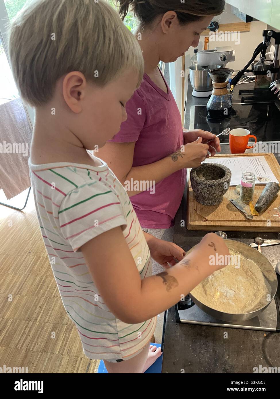 A little boy helps his mother cook Stock Photo - Alamy
