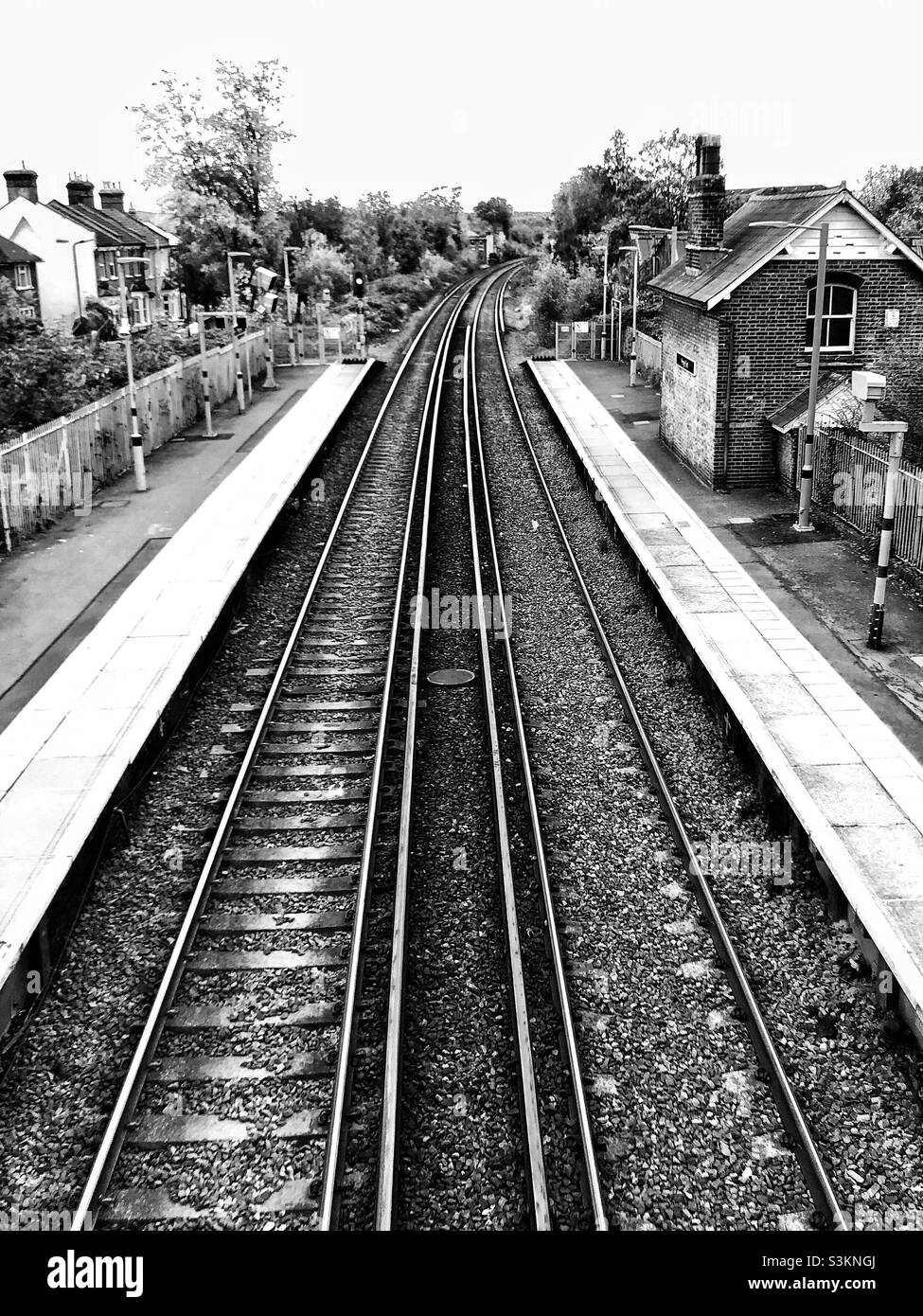 Big steel rail. Suburban railway station, London Stock Photo - Alamy