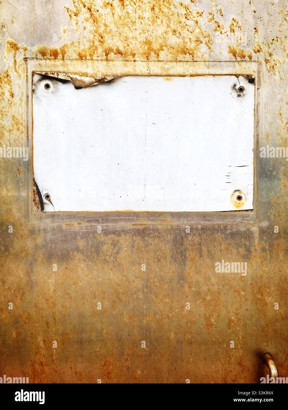 Detail of a faded and peeling sign on a rusting metal door, Hong Kong ...