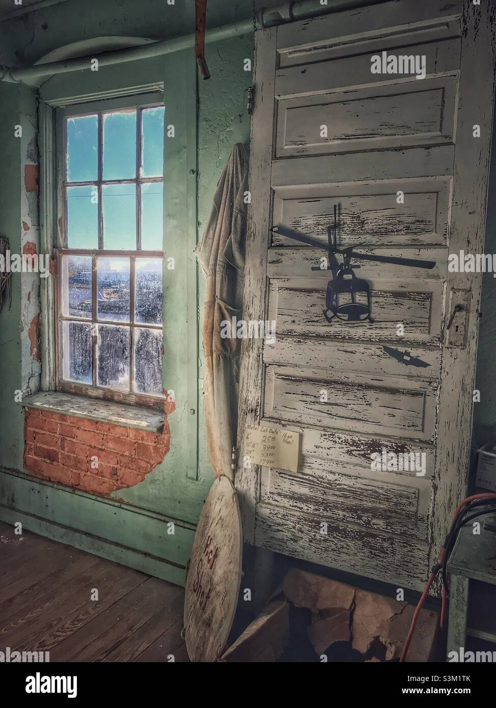 Old door on display beside mullioned window in old store Stock Photo ...