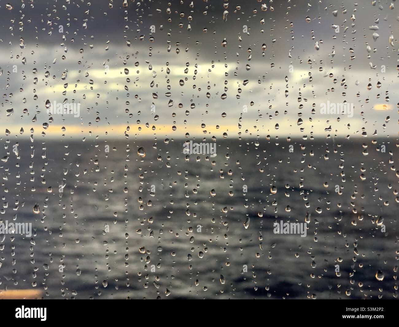 View through window covered with rain drops Stock Photo - Alamy