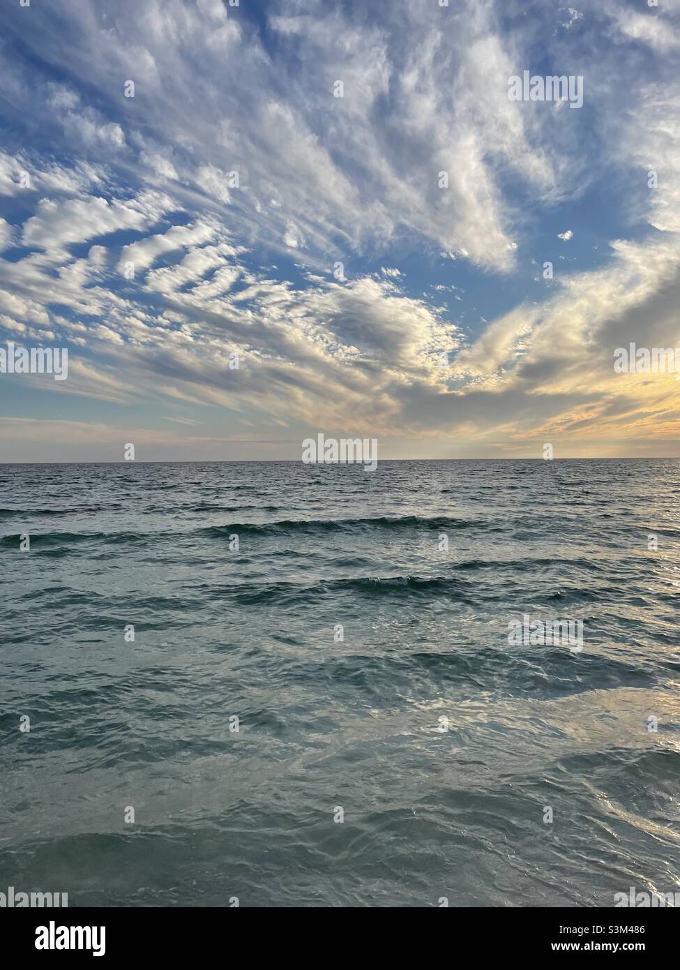 Cloudy sunset skies over the Gulf of Mexico water Florida Emerald Coast ...