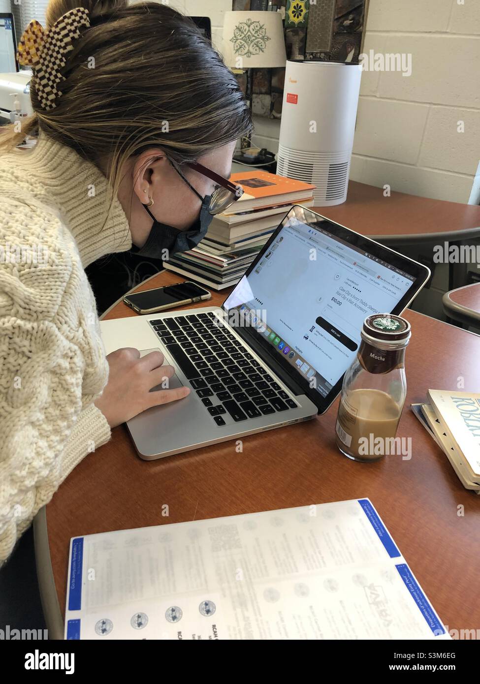 Girl with glasses reading computer screen at work Stock Photo - Alamy