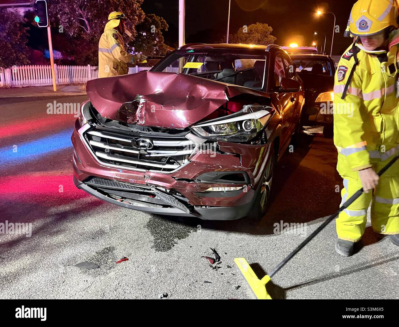 Firemen cleanup oil spill from a traffic accident involving a Hyundai ...