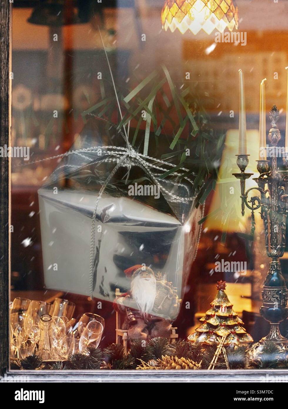 A display window of the shop shows the little Santa Claus and the other ...