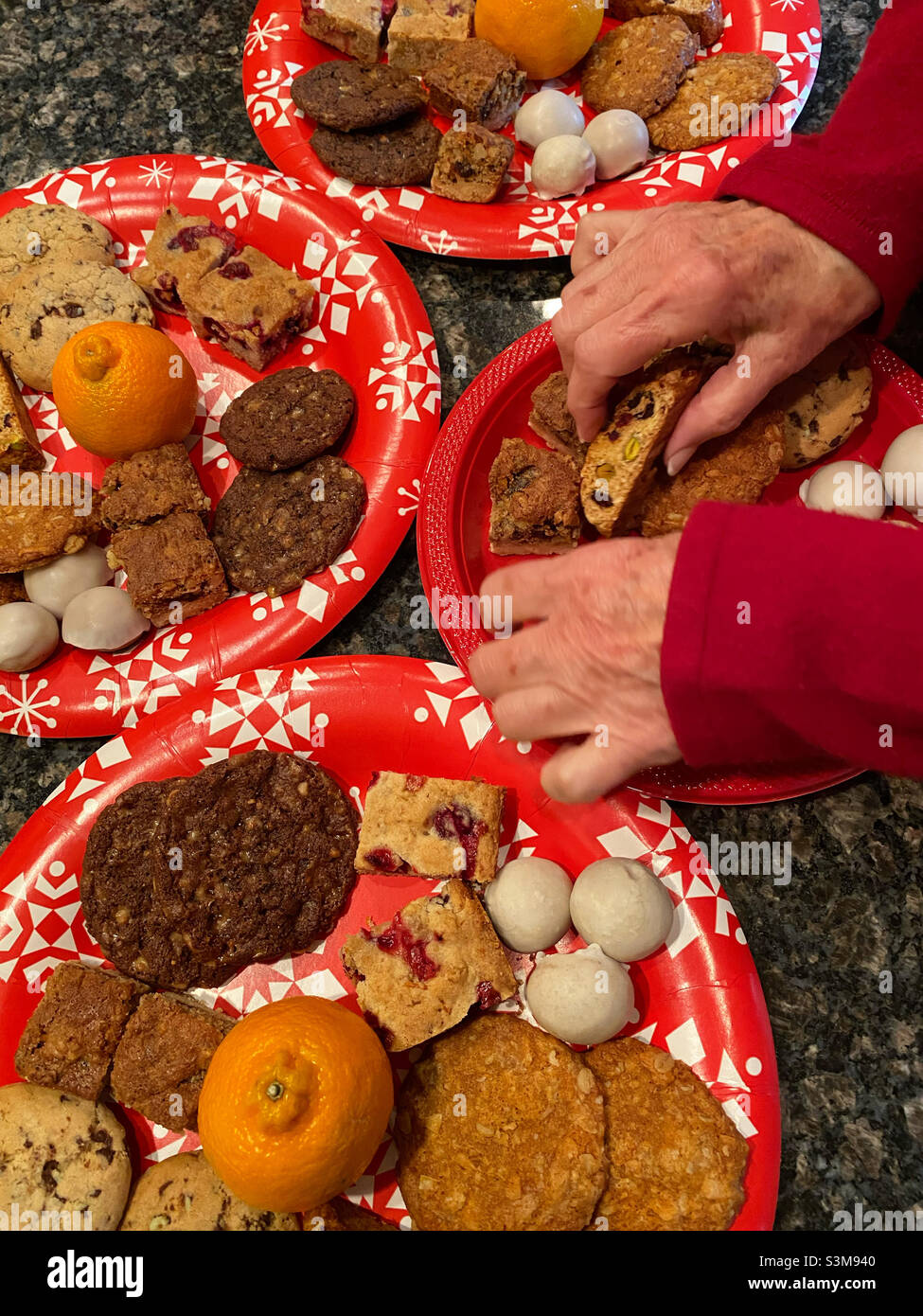 Plates of holiday cookies being prepared as gifts Stock Photo - Alamy