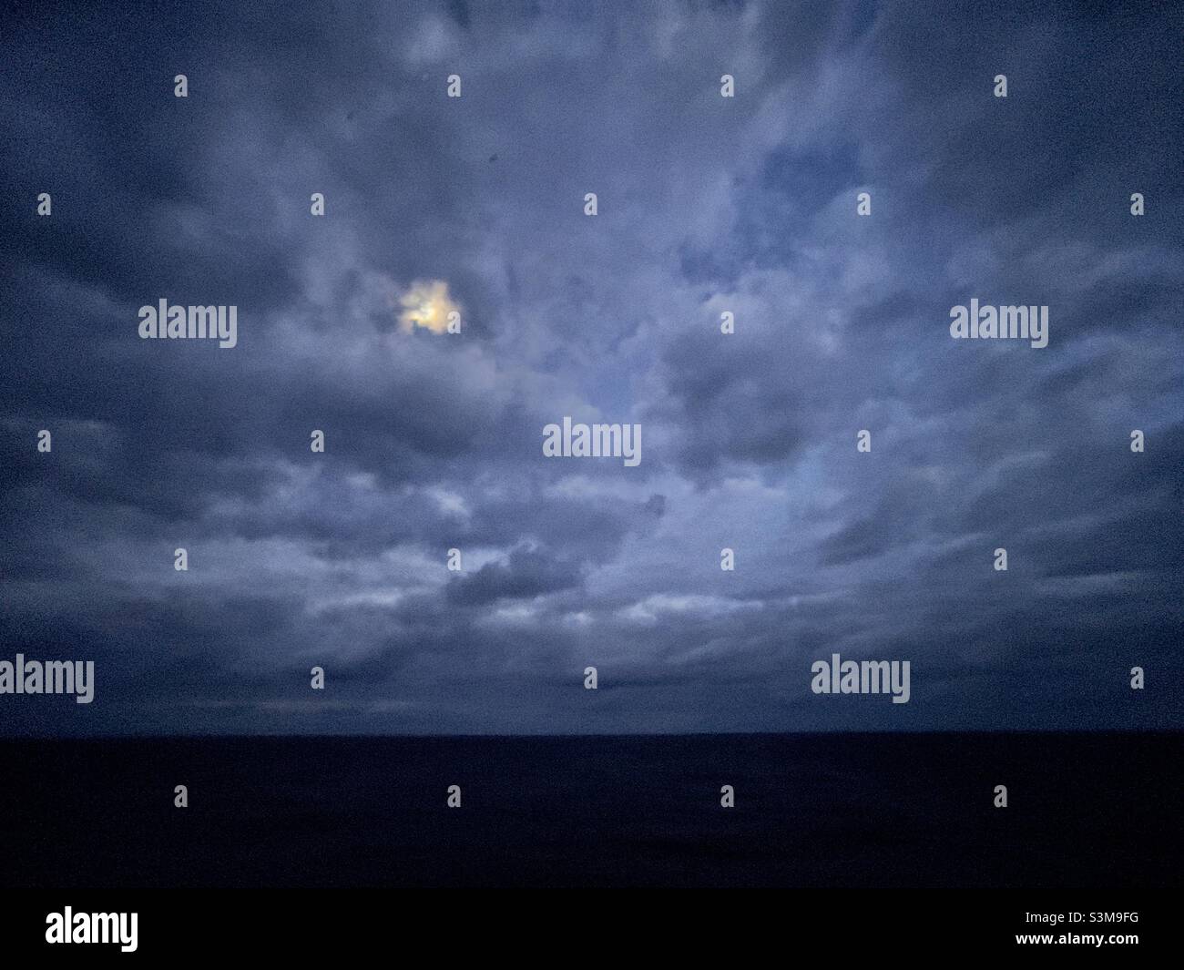 Moon behind clouds hi-res stock photography and images - Alamy