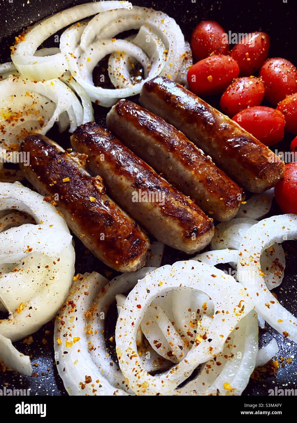 Breakfast cooking with onion, grape tomatoes and sausage Stock Photo ...