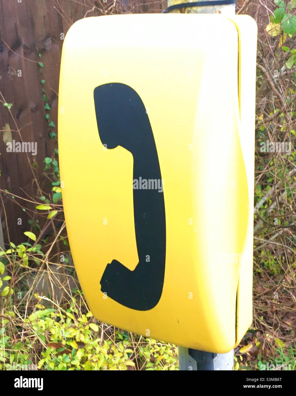 Yellow case holding a telephone for use by drivers of large or slow ...