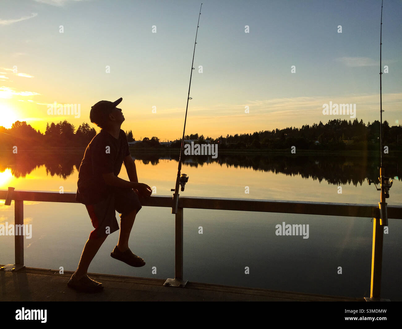 Boy watching calm lake hi-res stock photography and images - Alamy