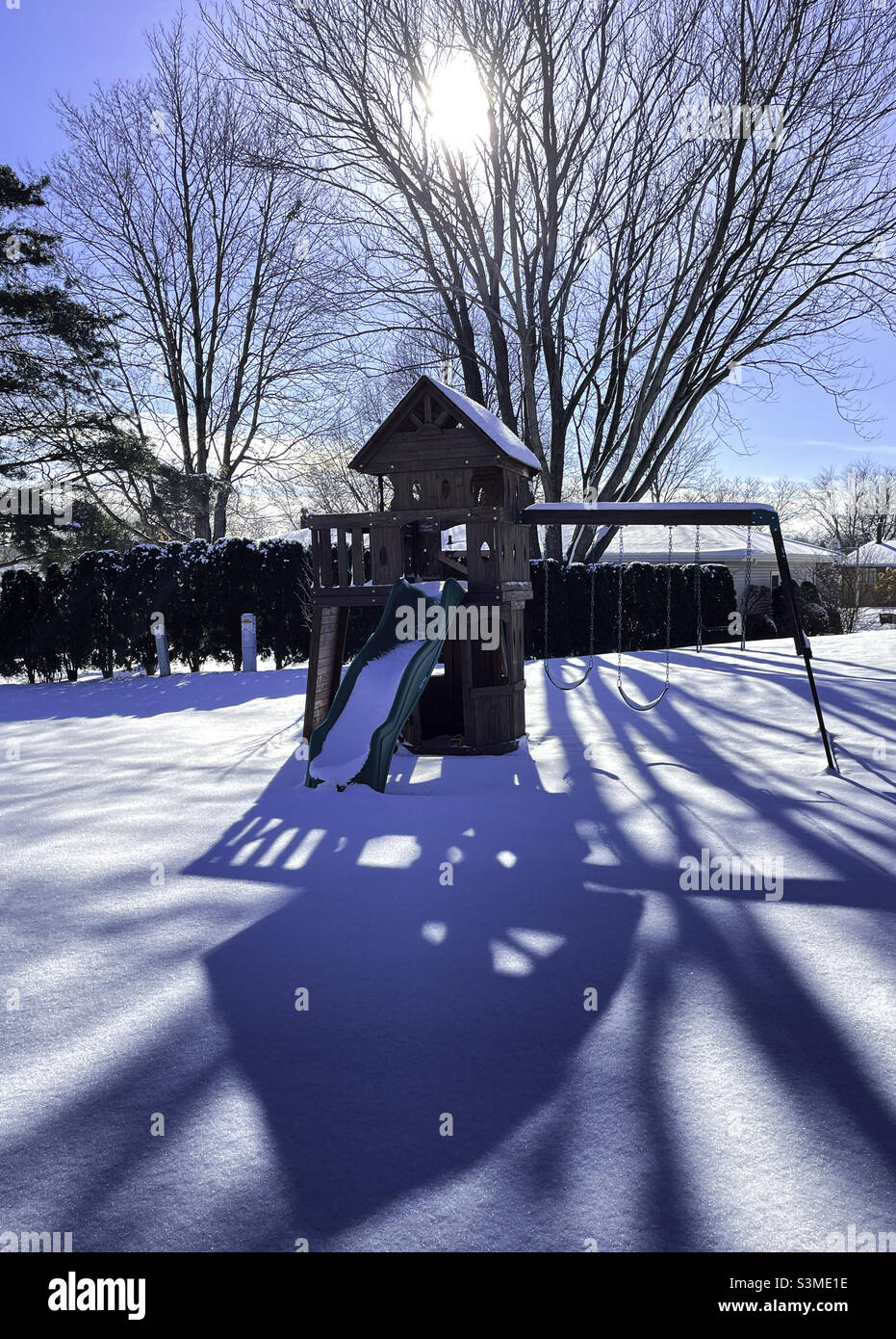 DUBUQUE, IOWA, December 2021--Landscape photo of kids play set covered ...
