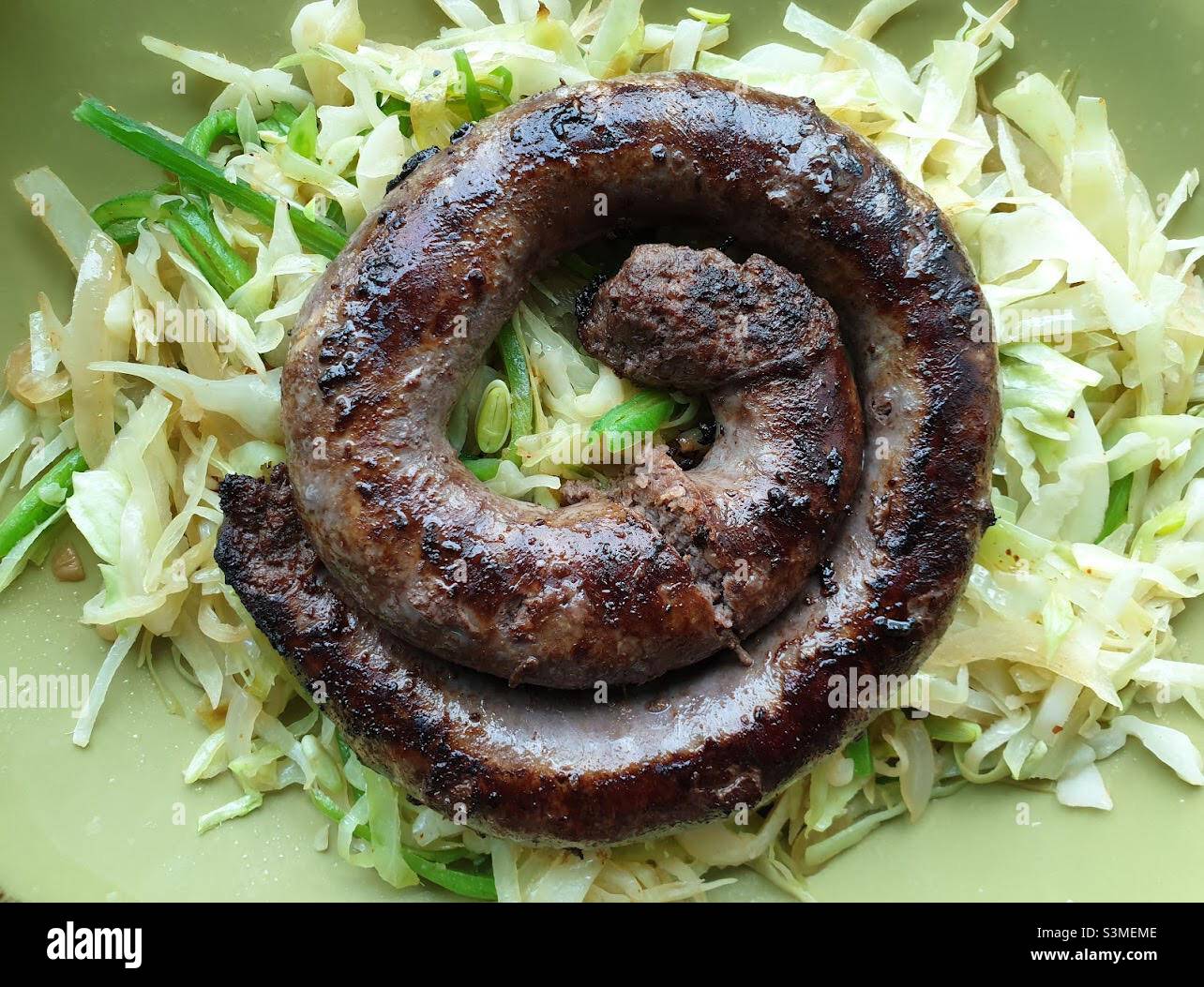 Boerewors, boerewors sausage on a bed of sautéed cabbage Stock Photo ...