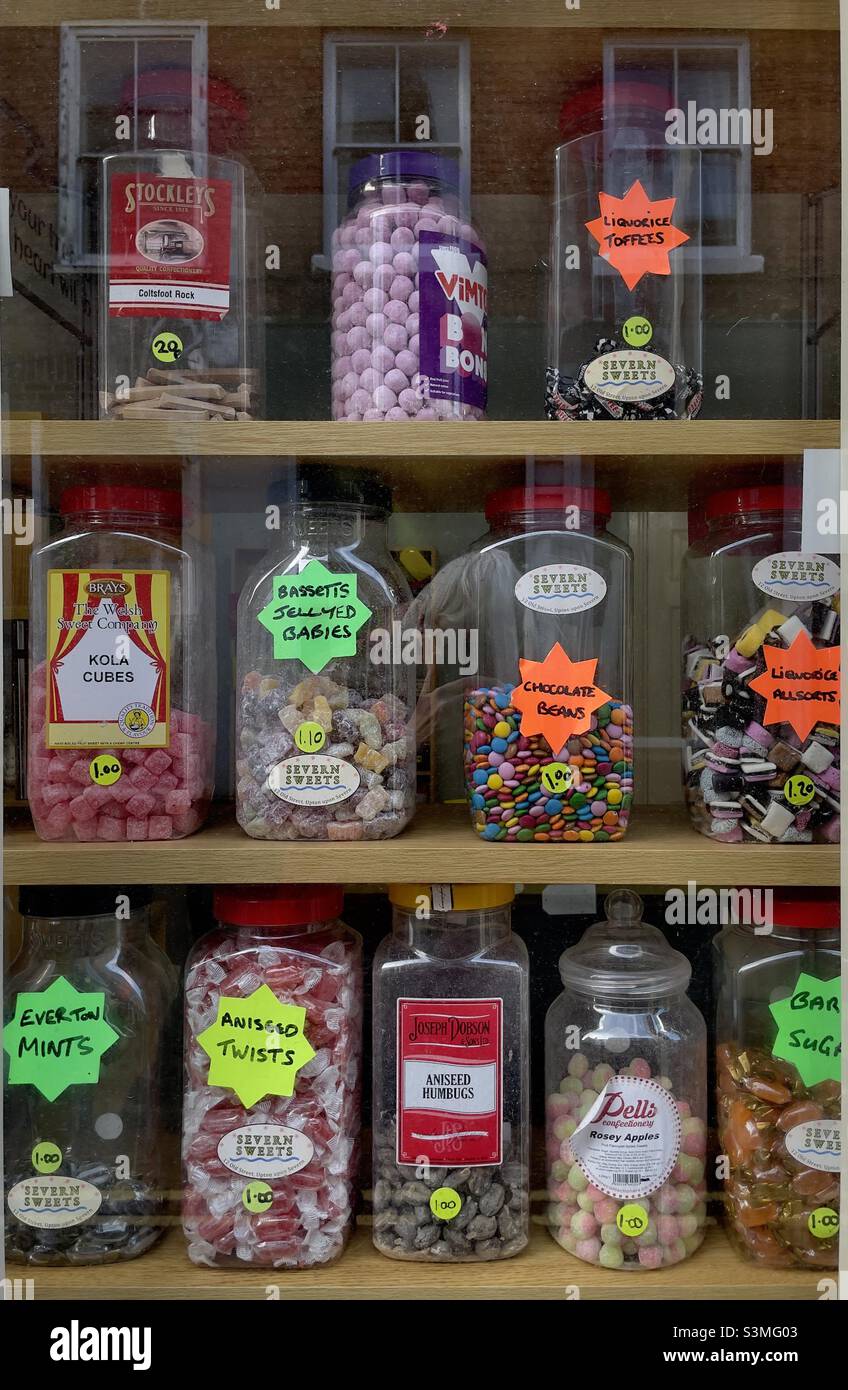 Rows of jars of sweets and confectionary in a shop window Stock Photo ...