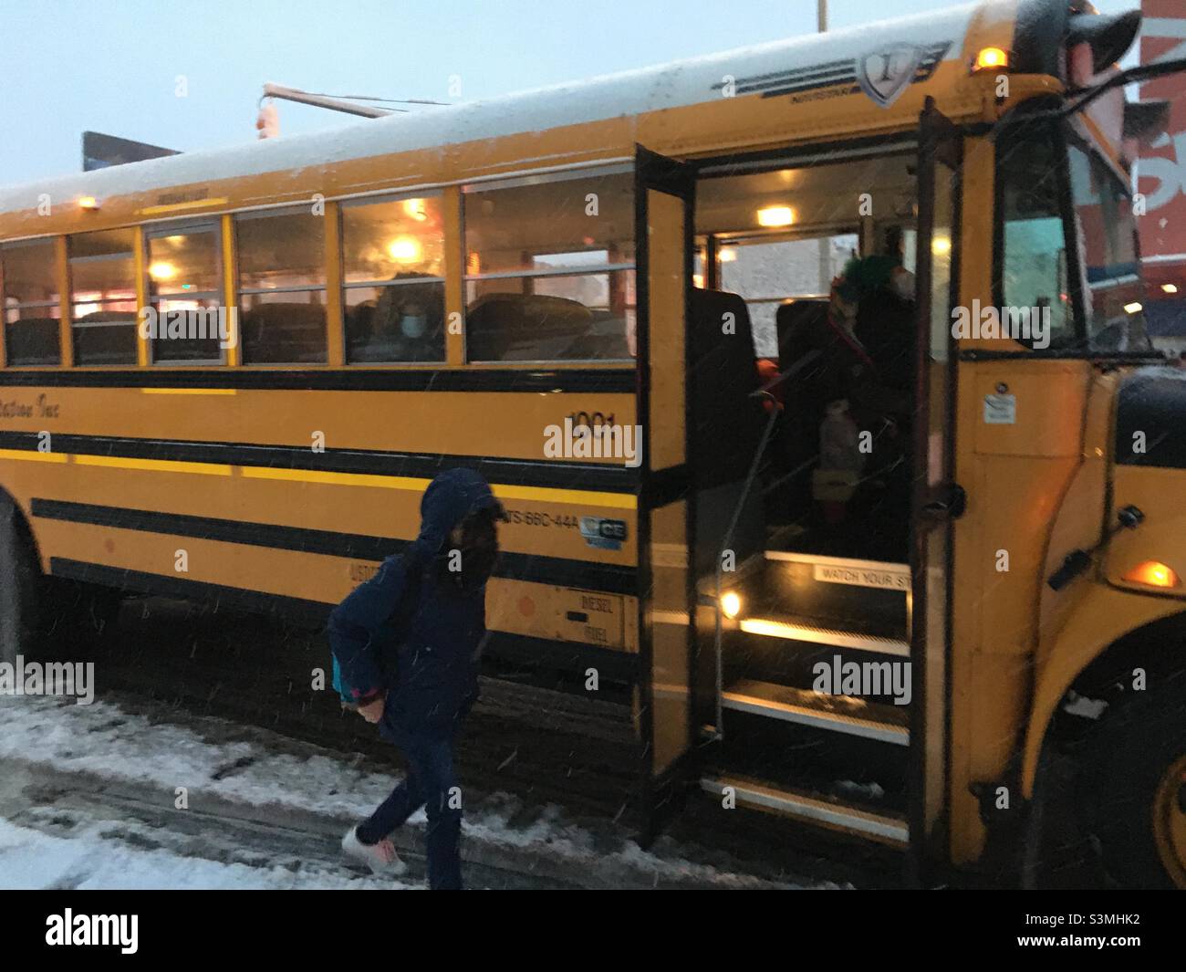 January 7th, 2022: student in New York getting aboard a school bud ...