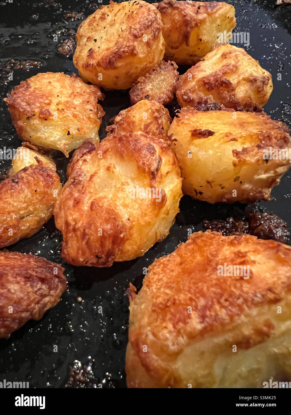 Roast potatoes in tray Stock Photo - Alamy