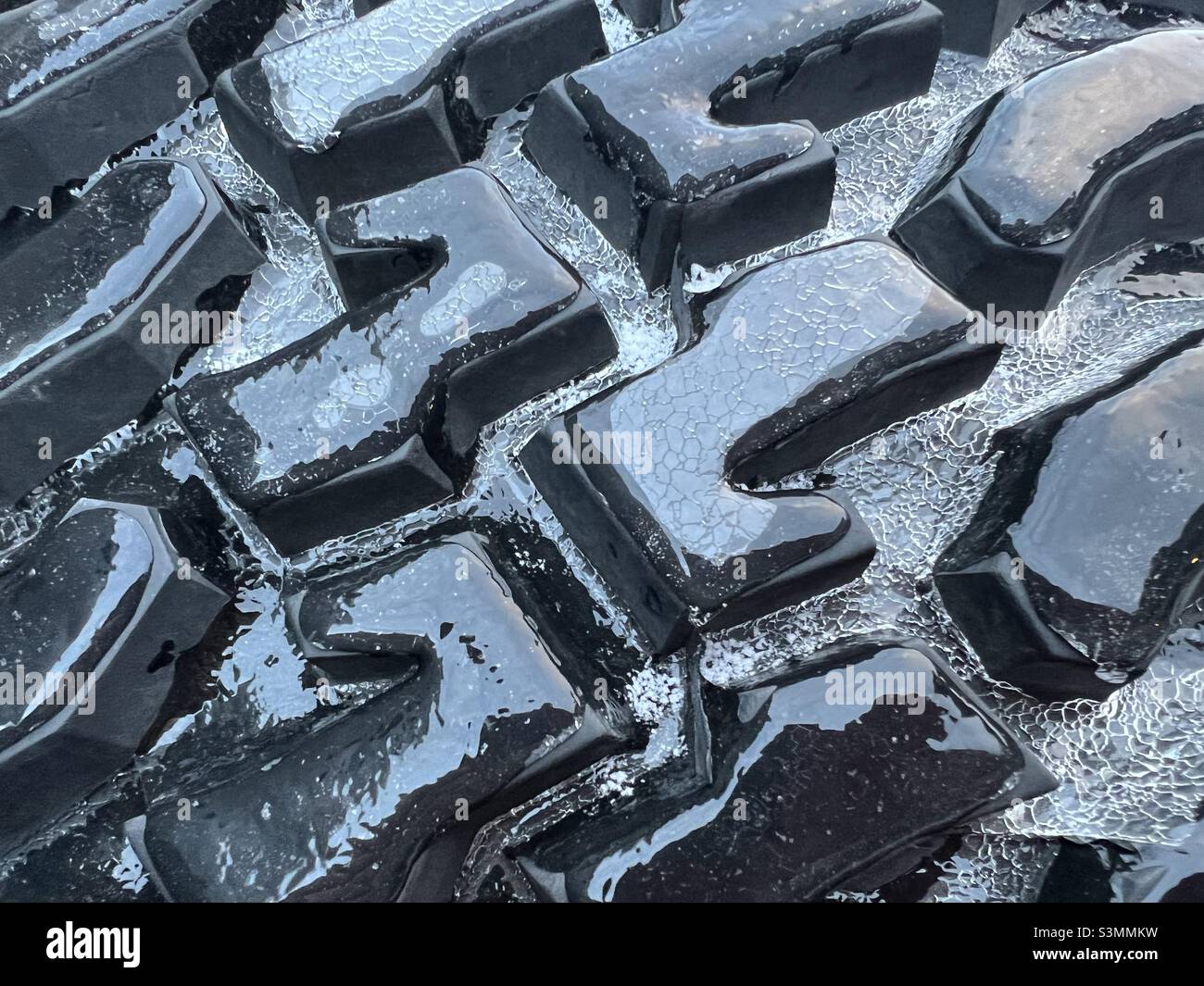 Off-road tire covered with glazed ice after ice storm in the northeast ...