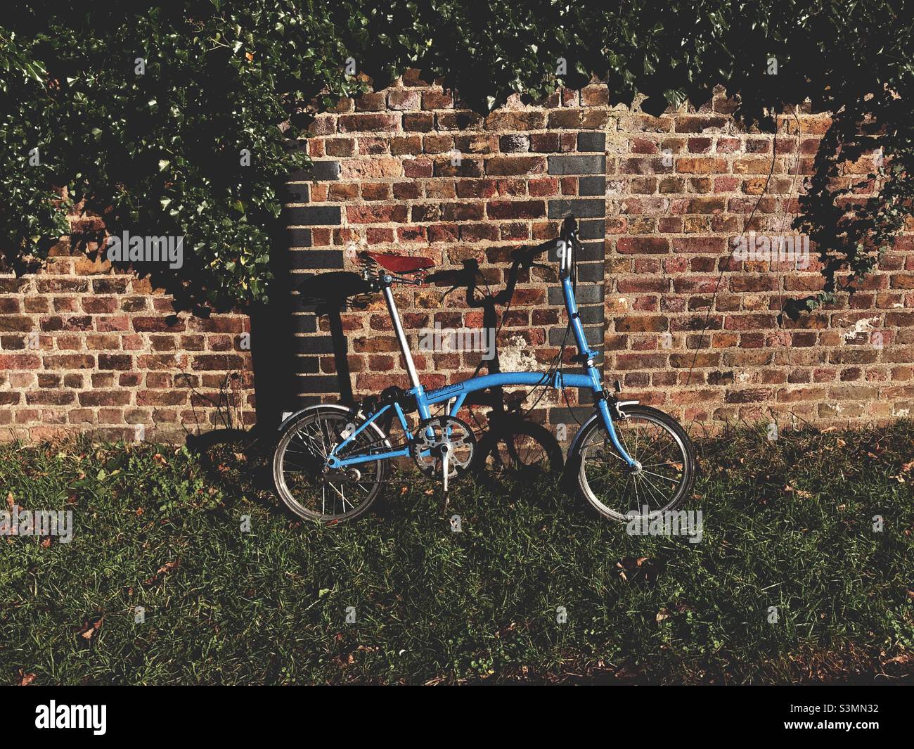 Handmade Folding bike by a brick wall Stock Photo - Alamy
