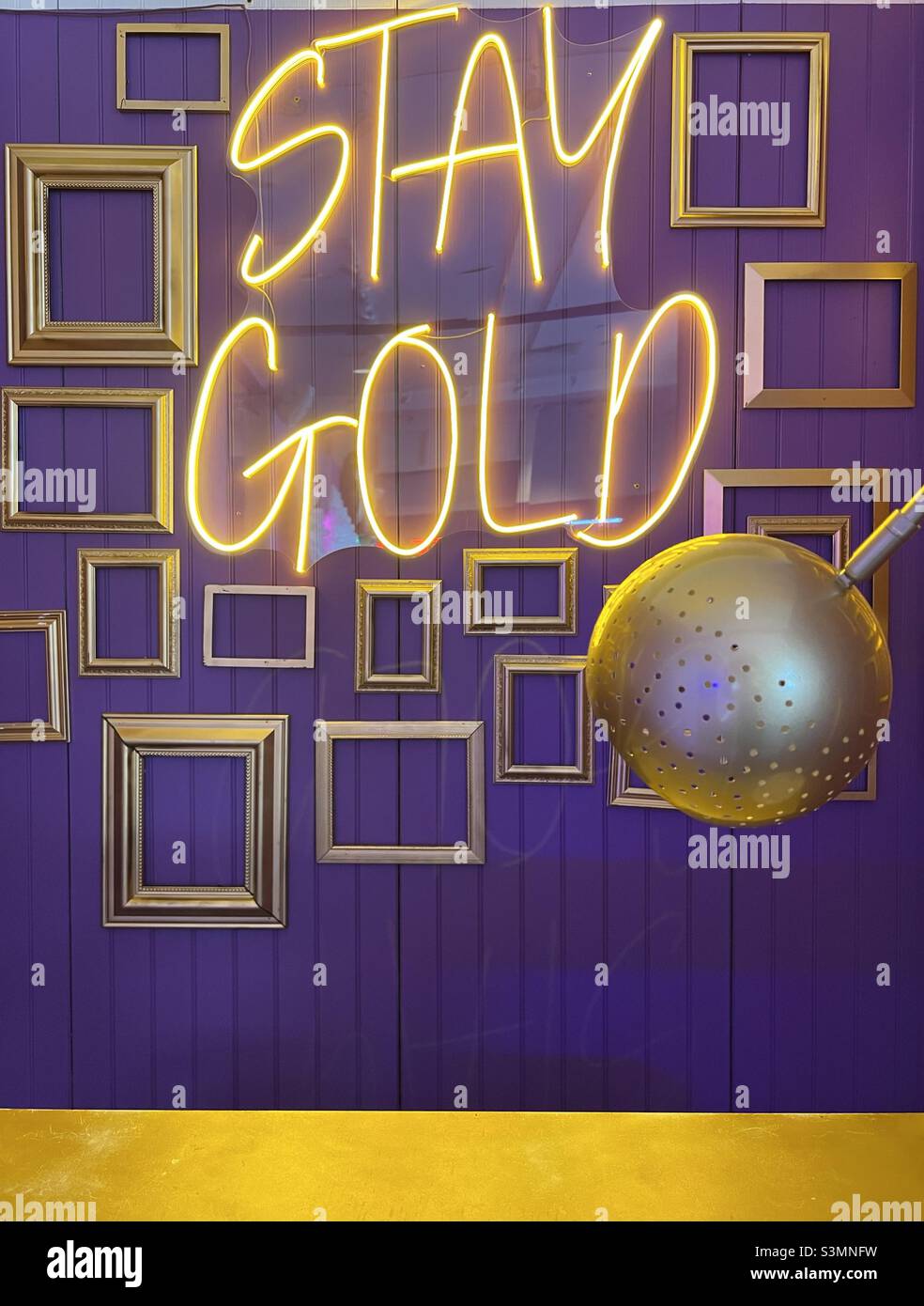 Neon sign with slogan stay gold and background decorations Stock Photo ...