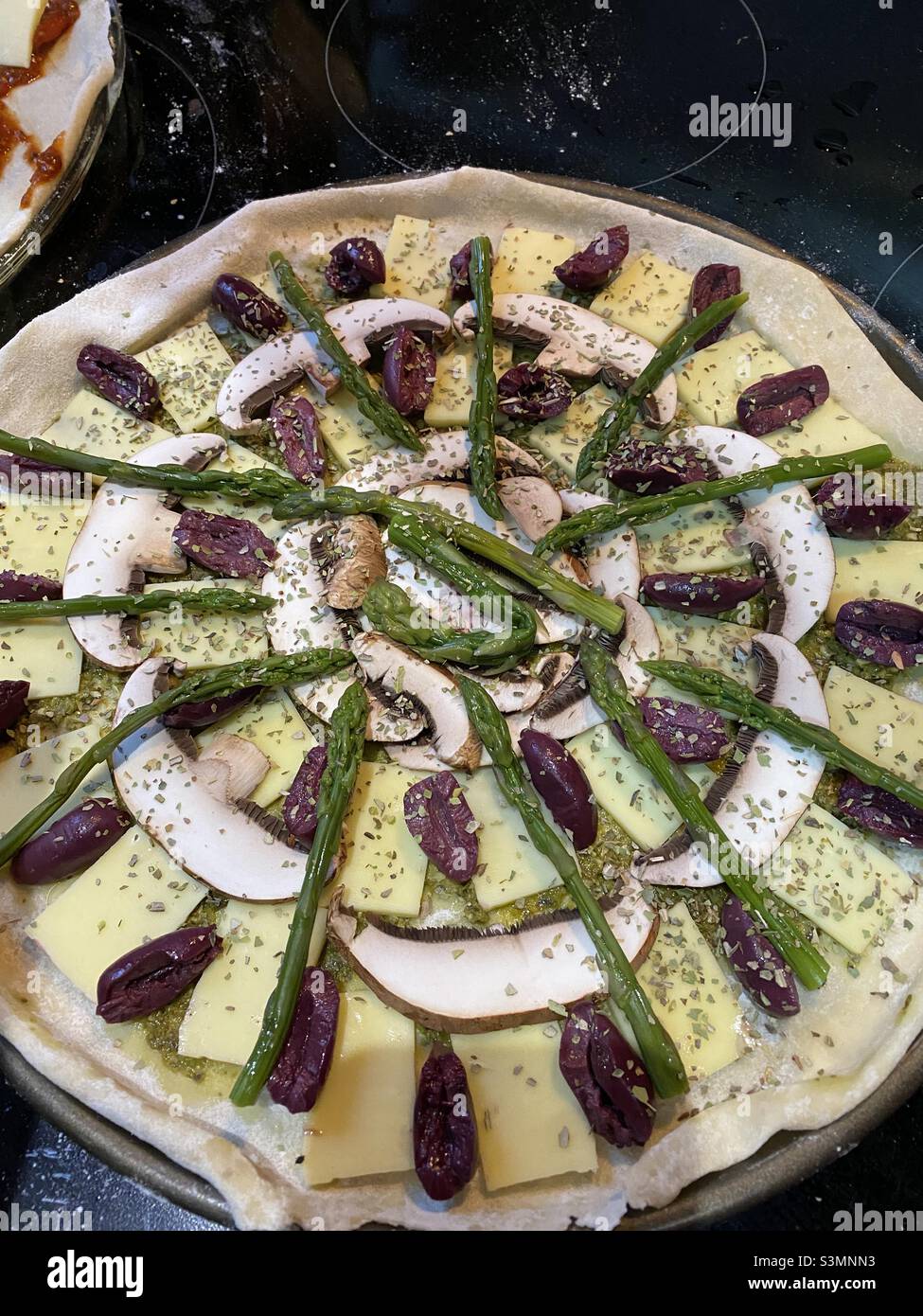Pizza waiting to be baked Stock Photo - Alamy