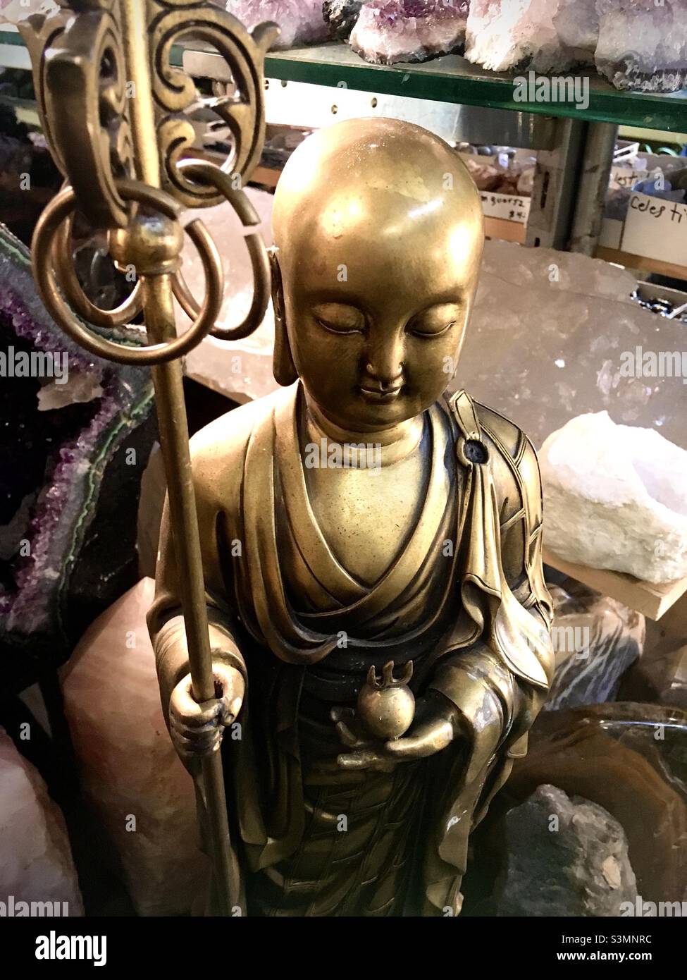 Spiritual brass Hindu God statue with rose crystals in the background ...