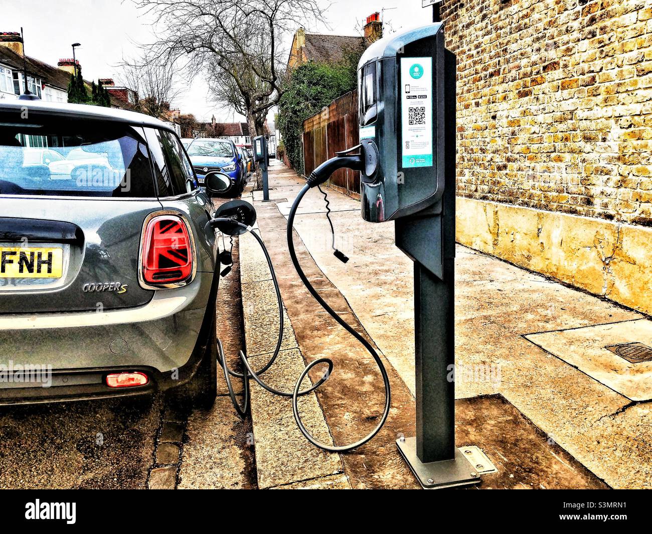 Electric mini copper car charging on roadside using the charger on ...