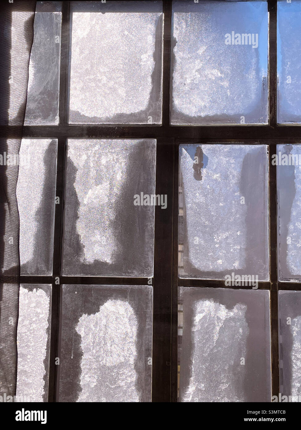Ice and frost covering casement glass window in a New York City ...