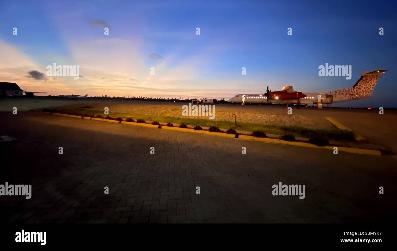 Aircraft set to take off during sunset Stock Photo - Alamy
