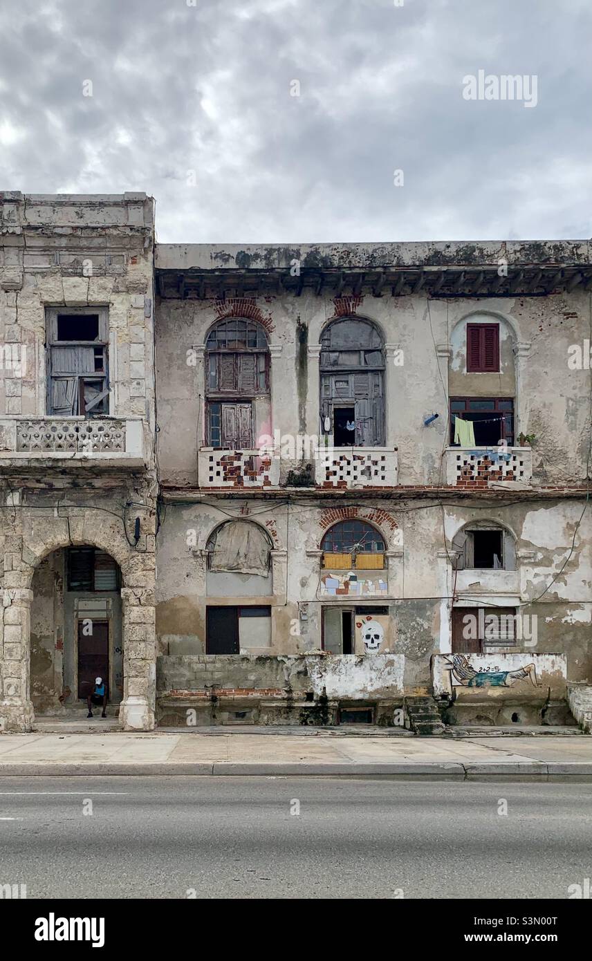 Old run-down building in Havana. In front of Malecón seaside avenue ...